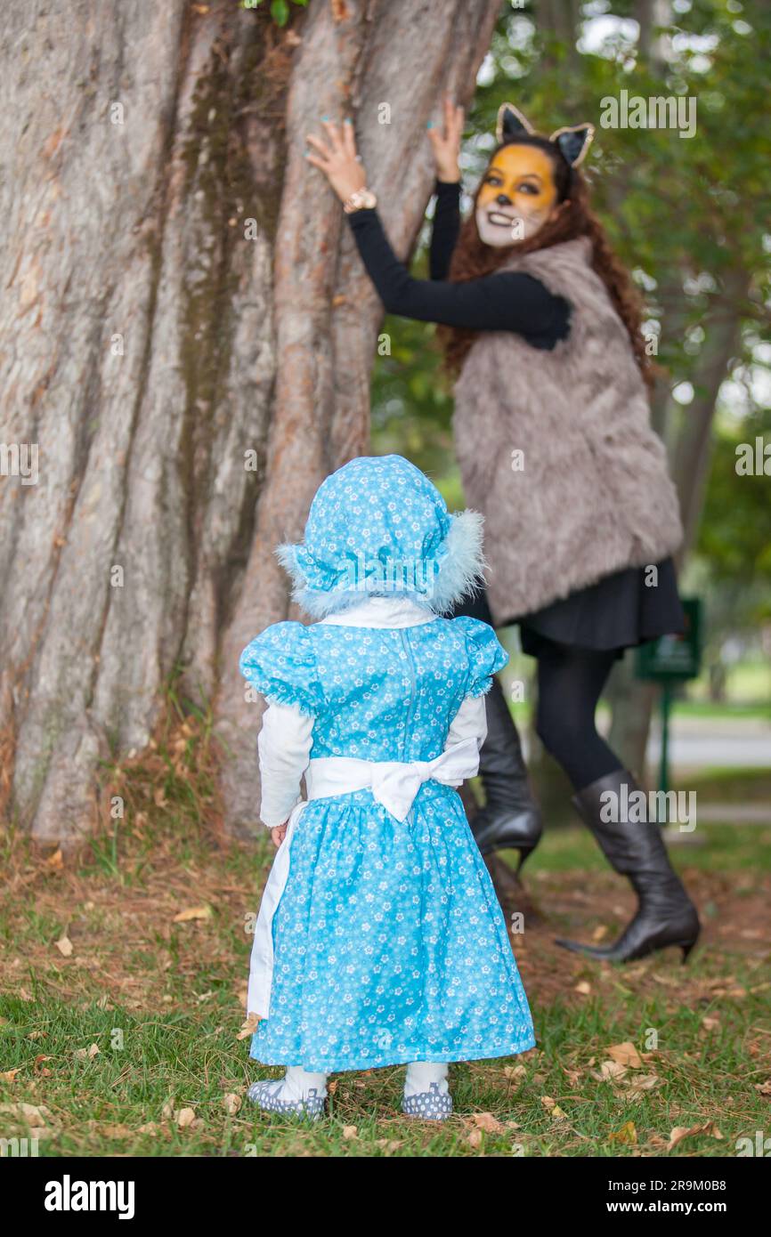 Little girl on grandma costume playing with her mom. Real family having ...
