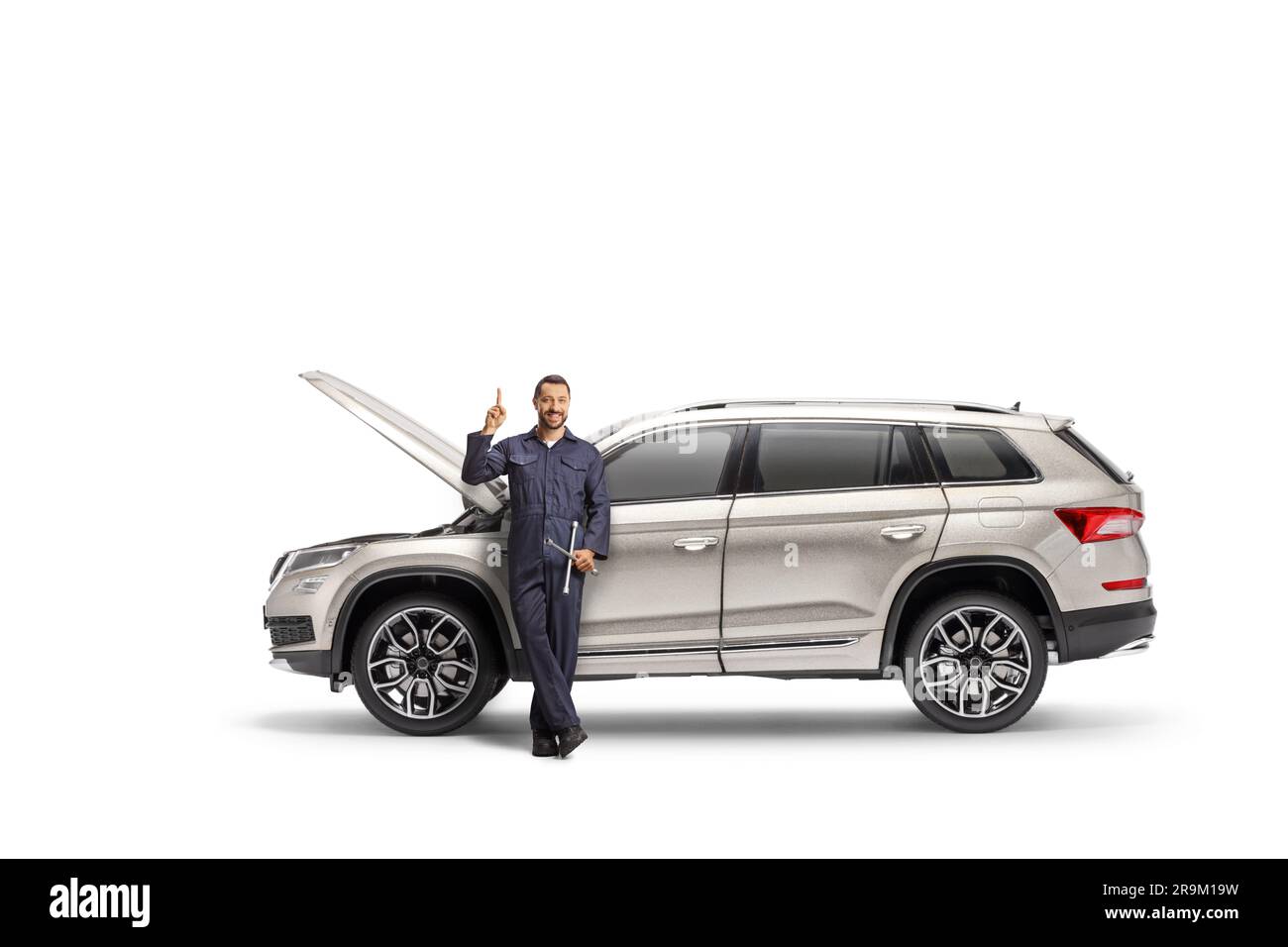 Auto mechanic leaning on a SUV with an open hood and pointing up ...