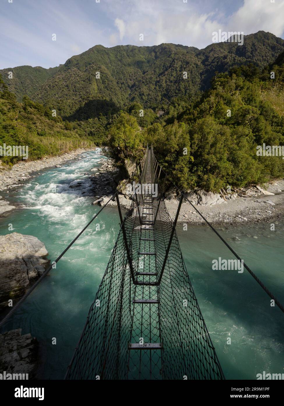 Cesspool Gorge hanging metal swing bridge leading over turquoise ...