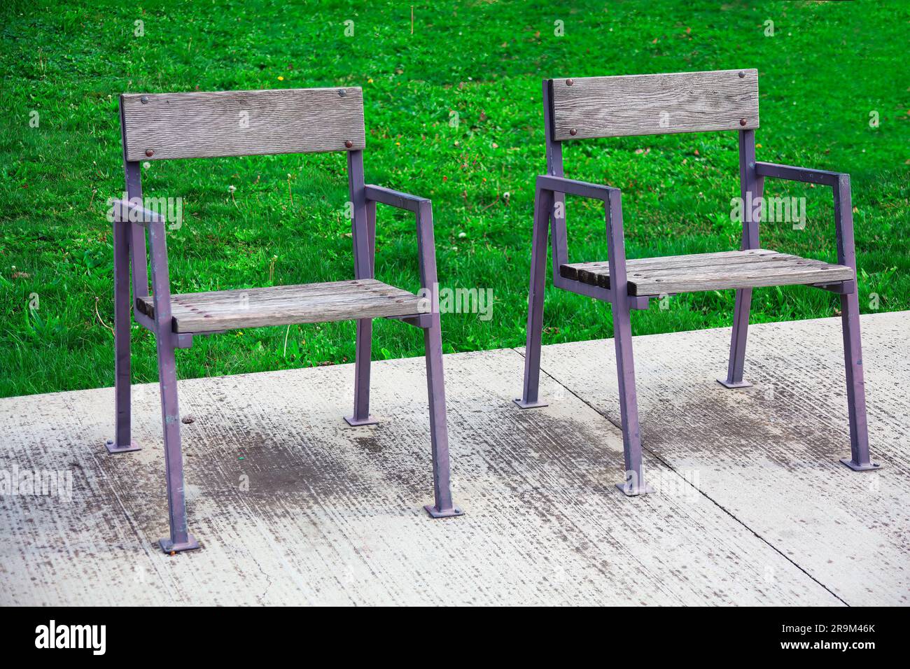 Wooden chairs in the park on a white wooden floor with green grass ...