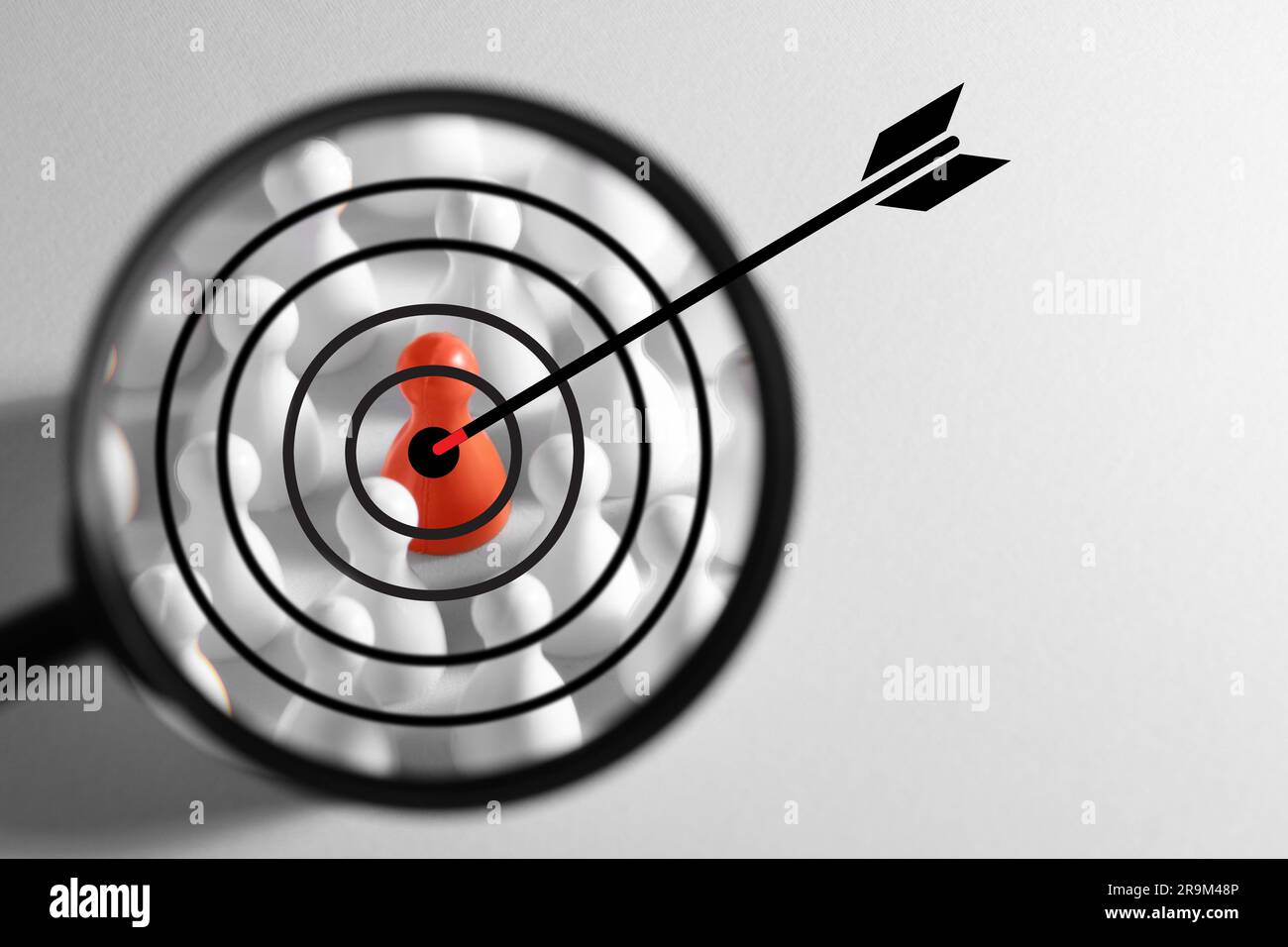 Arrow aiming to pawn, view through magnifying glass with target. White ...