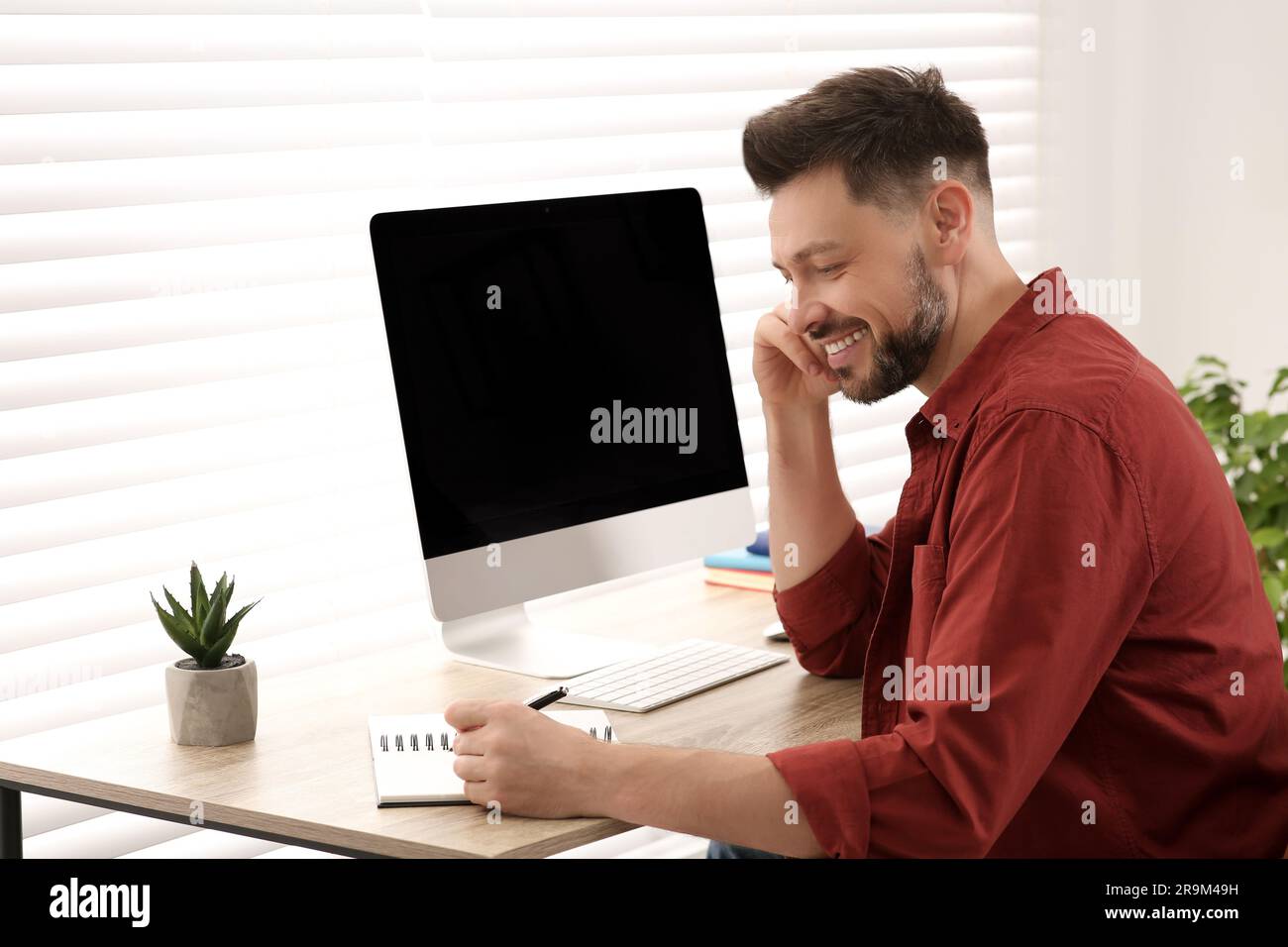 Online translation course. Man writing near computer indoors Stock ...