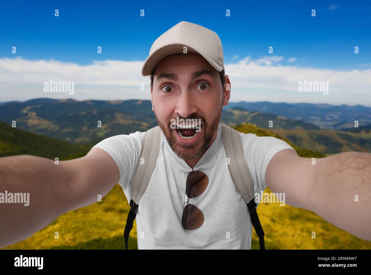 Smiling man taking selfie in beautiful mountains Stock Photo - Alamy