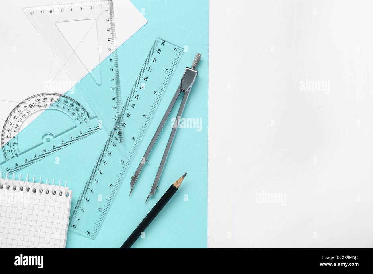 Different rulers, pencil and compass on color background, flat lay ...