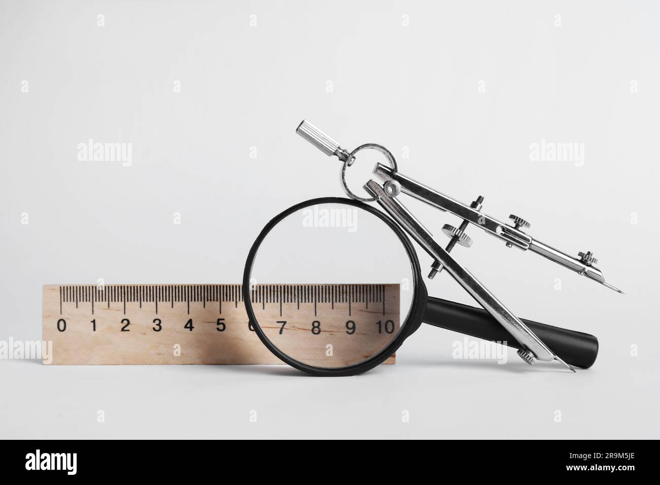 Ruler, magnifying glass and compass on white background Stock Photo - Alamy