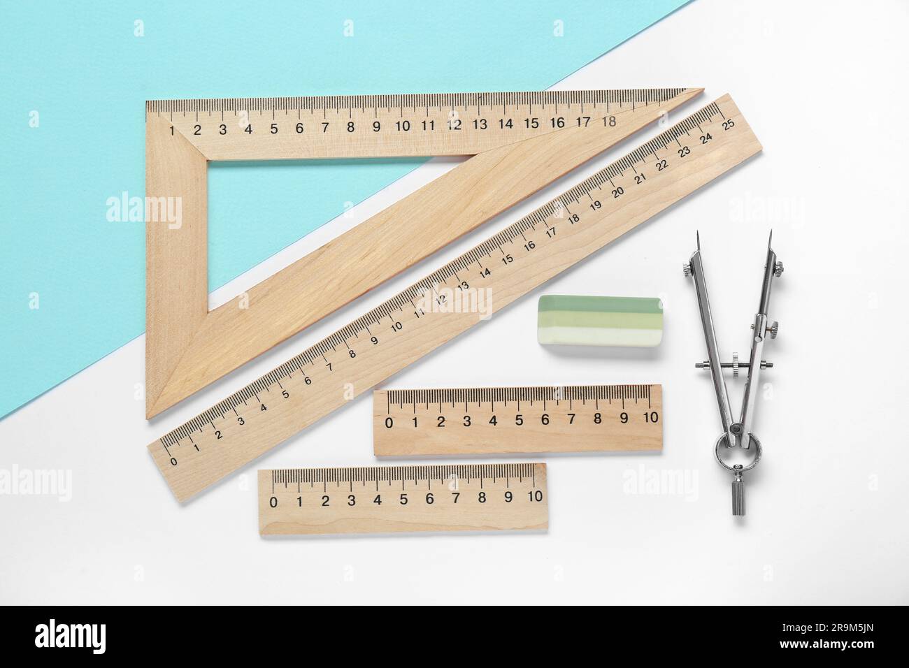 Flat lay composition with different rulers and compass on color ...