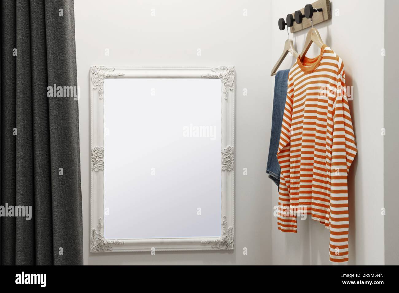 Dressing room with mirror in fashion store. Stylish design Stock Photo ...