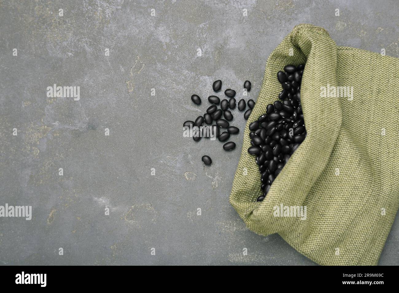 Sack of raw black beans on grey table, top view. Space for text Stock ...
