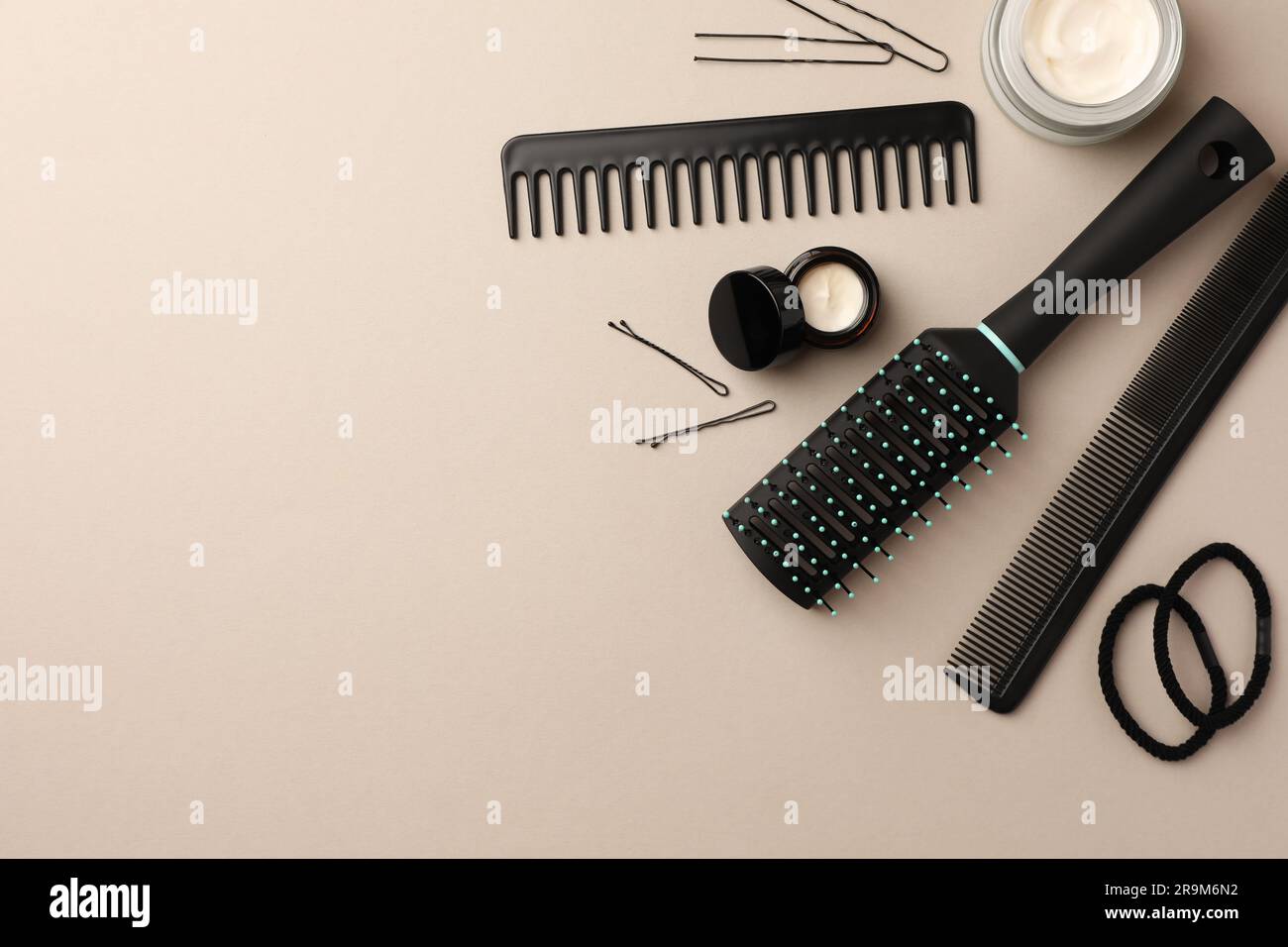 Brush, combs and different hair products on light grey background, flat ...