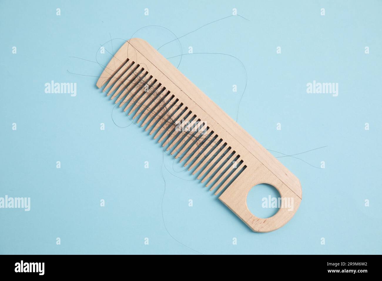 Wooden comb with lost hair on light blue background, top view Stock ...