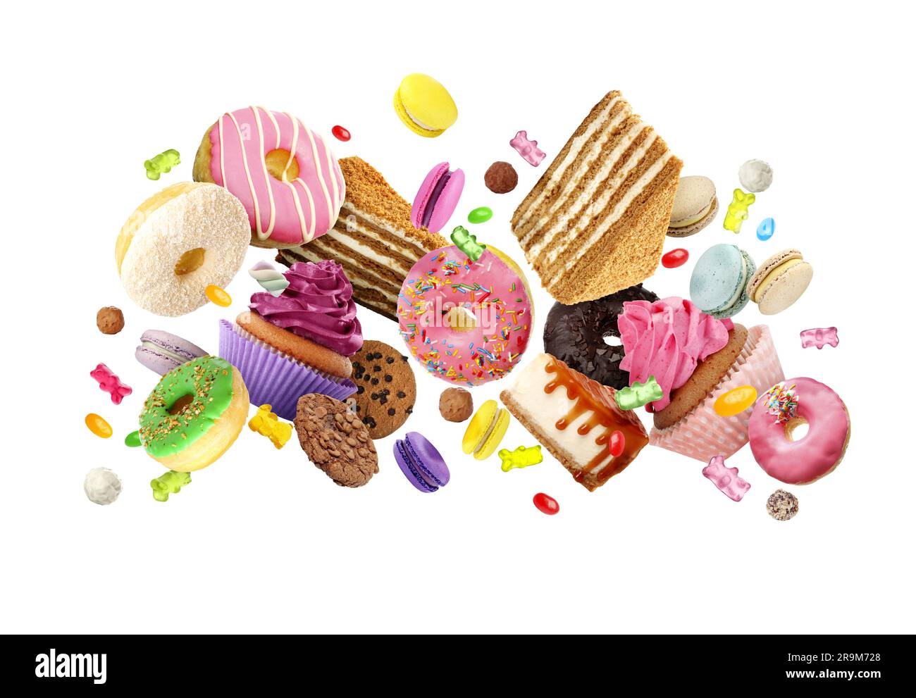 Many delicious sweets falling on white background Stock Photo - Alamy
