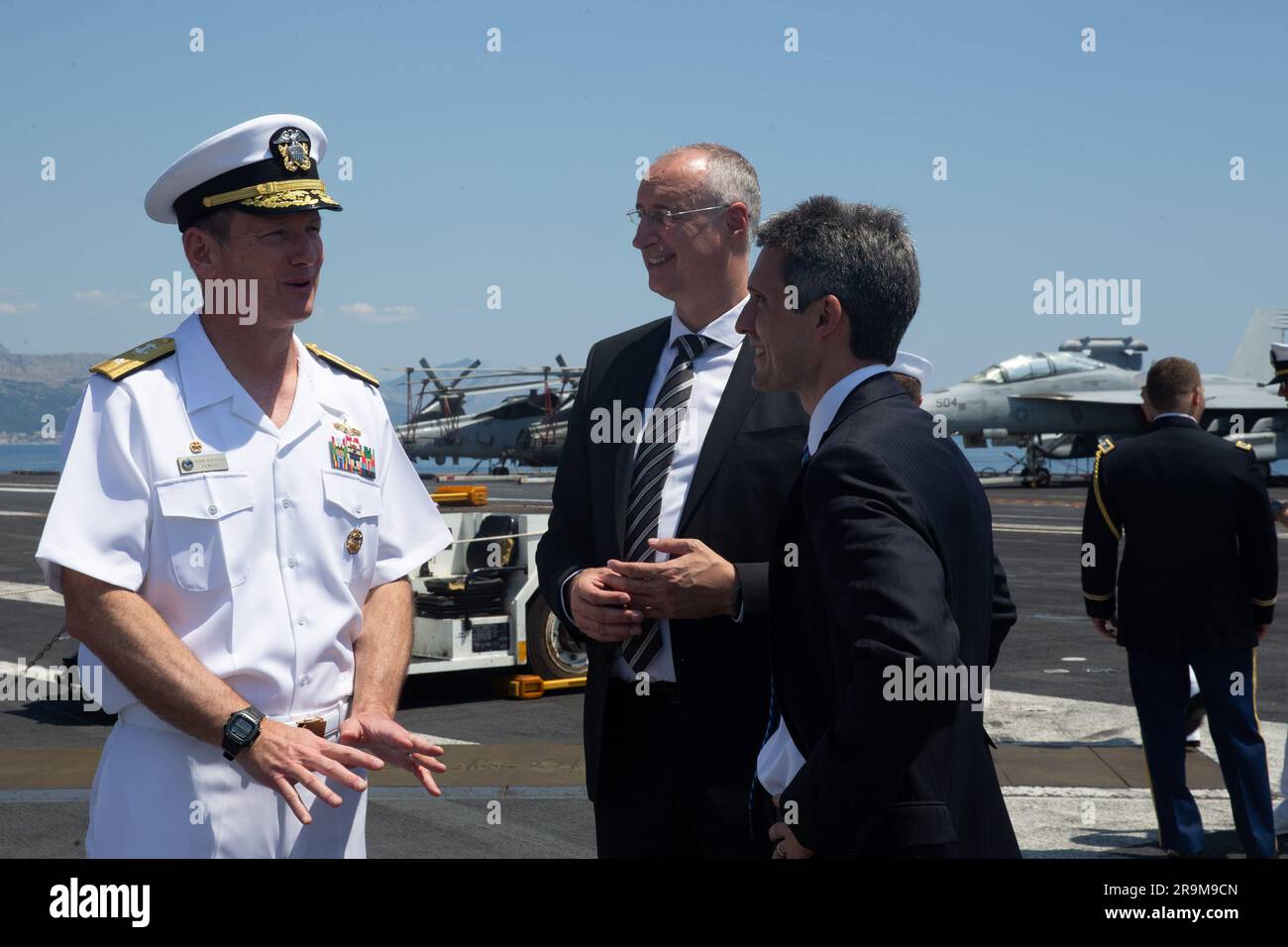 Rear Adm. Erik Eslich, left, commander, Carrier Strike Group (CSG) 12 ...