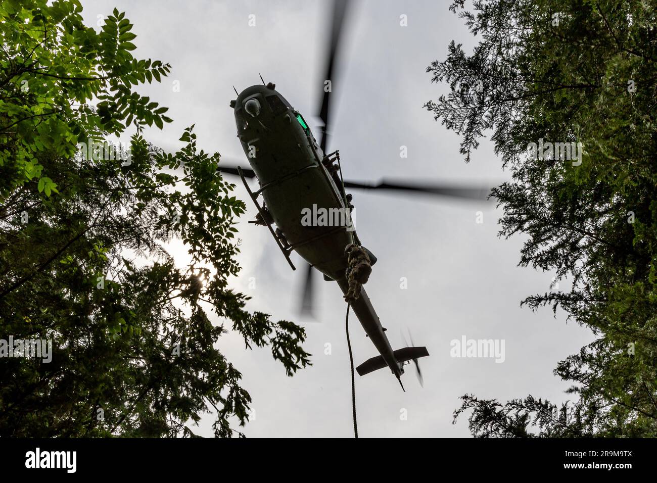 A U.S. Marine with 3rd Reconnaissance Battalion fast ropes from a UH-1Y ...