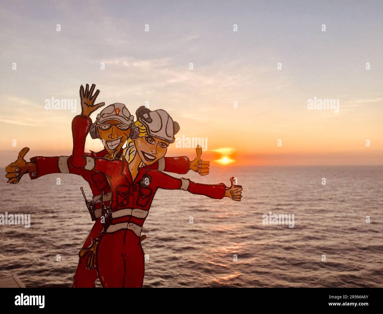 The paper-made oil rig workers standing with the ocean background Stock ...