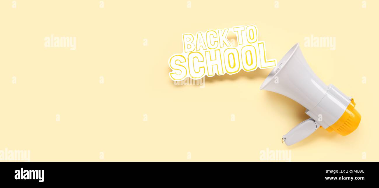 Megaphone and inscription BACK TO SCHOOL on beige background with space ...