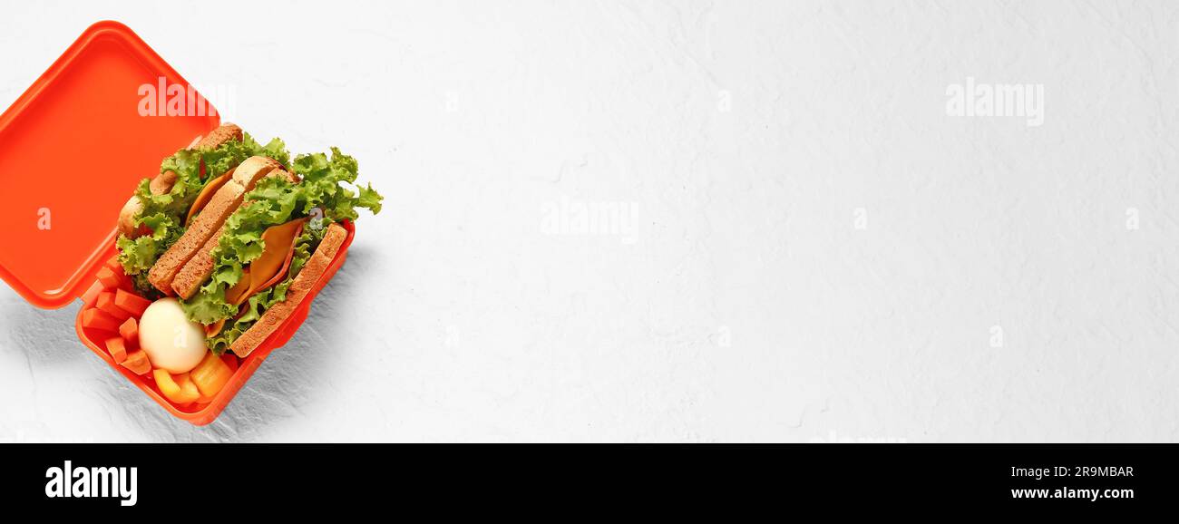 Lunch box of tasty food on light background with space for text Stock ...
