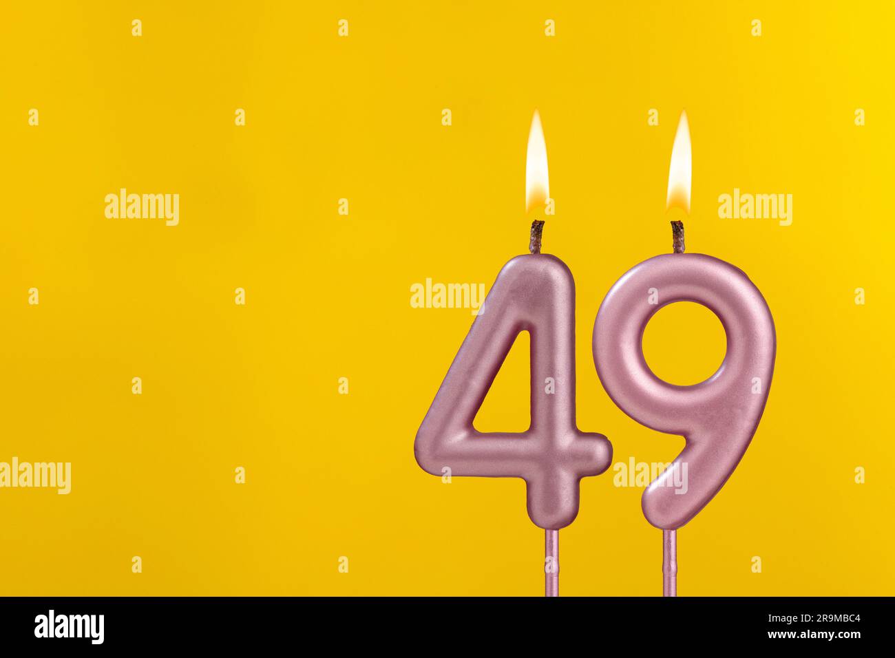 Birthday candle number 49 - Birthday celebration on yellow background ...