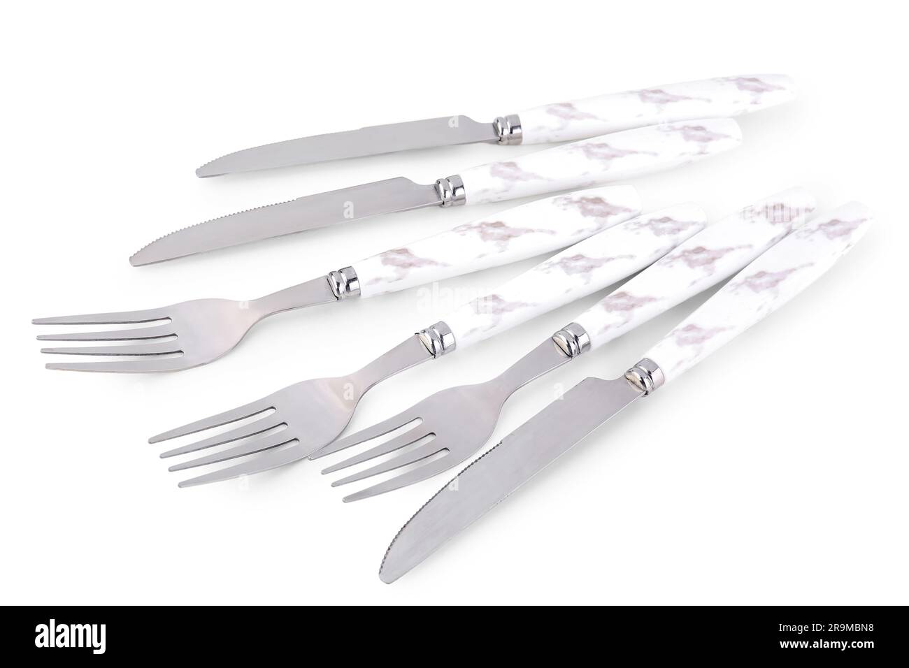 Stainless steel forks and knives with plastic handles on white ...