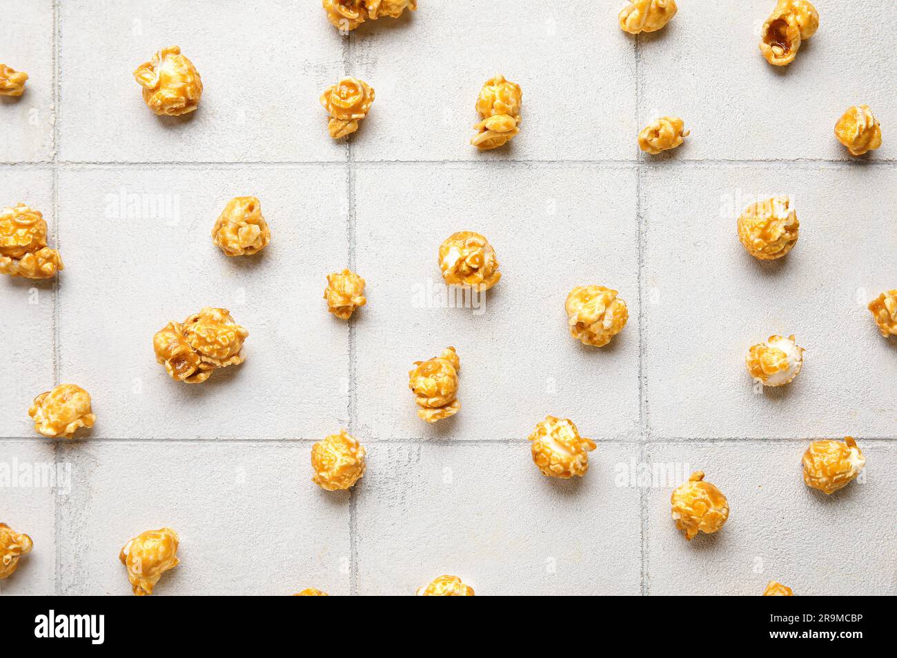 Tasty popcorn on white tile background Stock Photo - Alamy