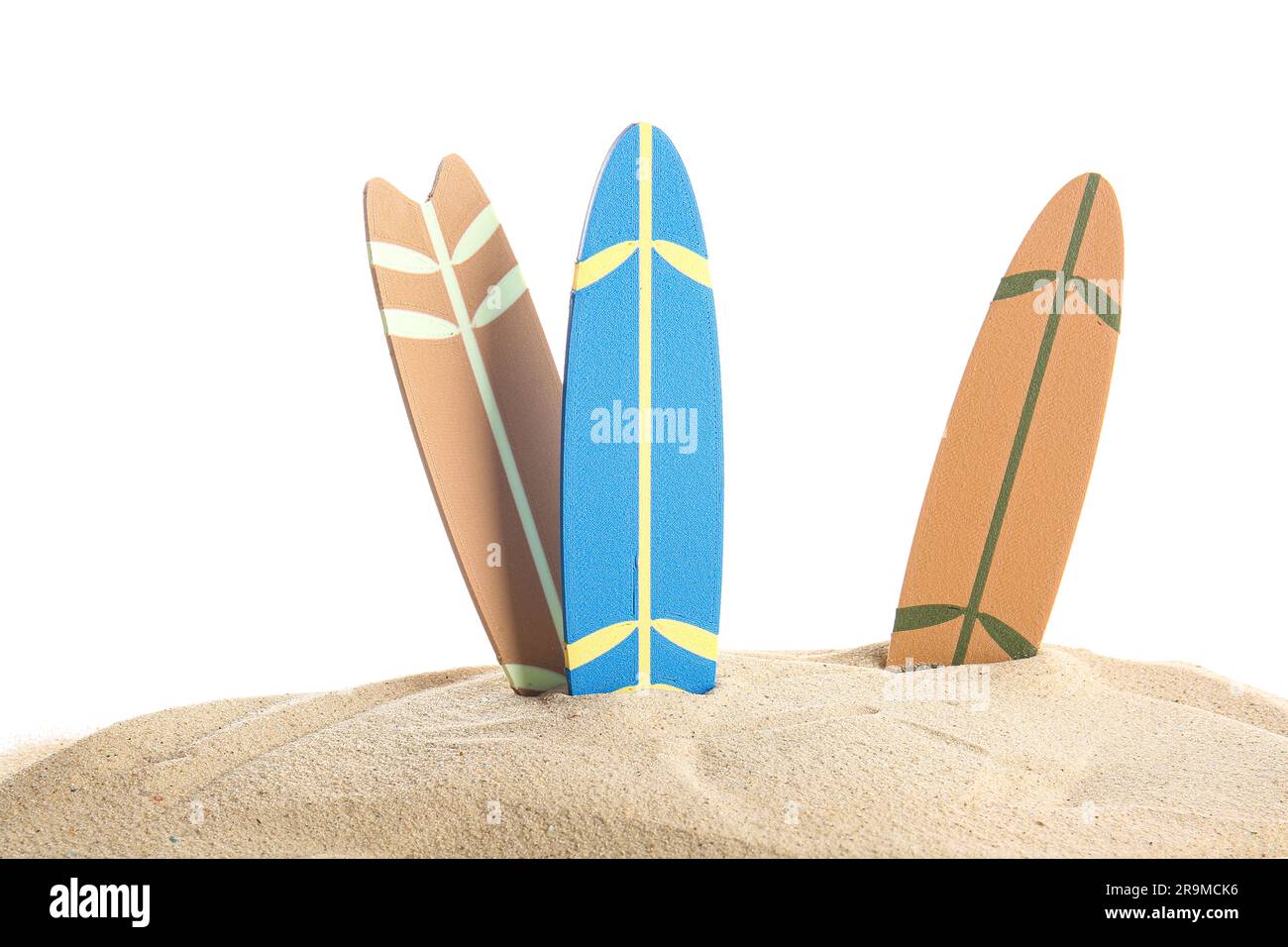 Mini surfboards on sand against white background Stock Photo - Alamy