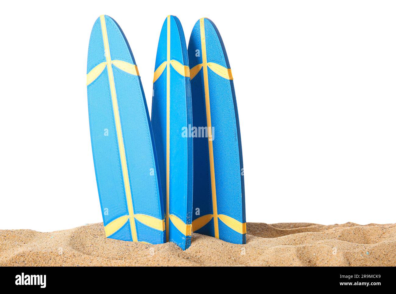 Mini surfboards on sand against white background Stock Photo - Alamy