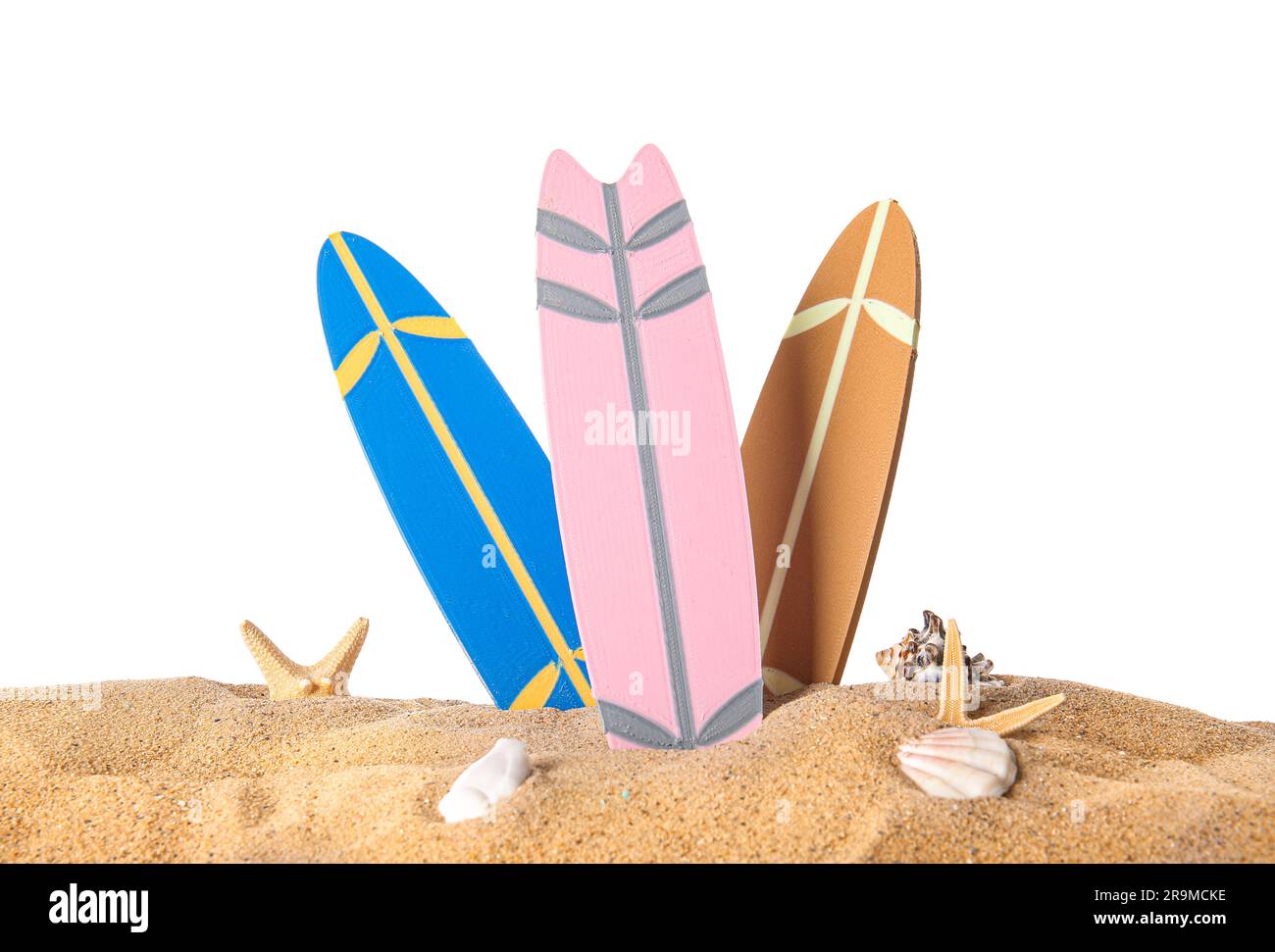 Mini surfboards with seashells and starfishes on sand against white ...