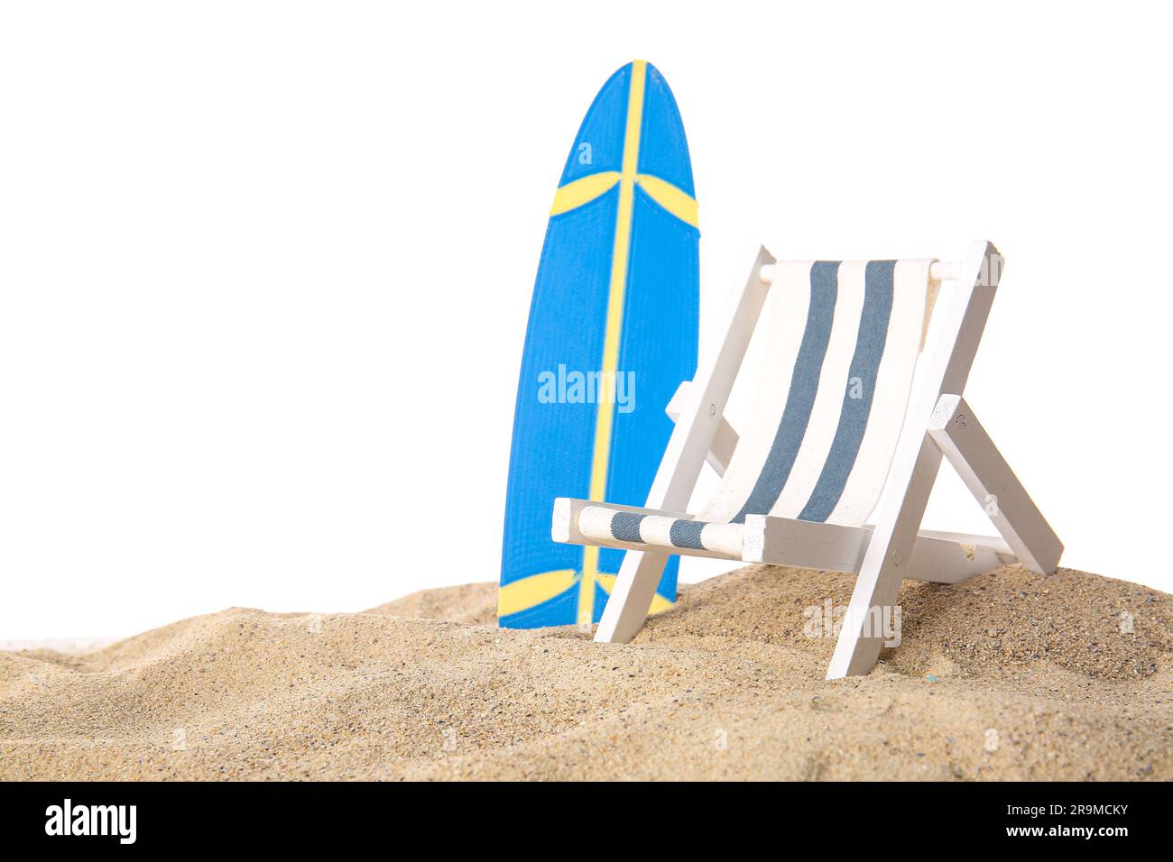 Mini surfboards with deckchair on sand against white background Stock ...