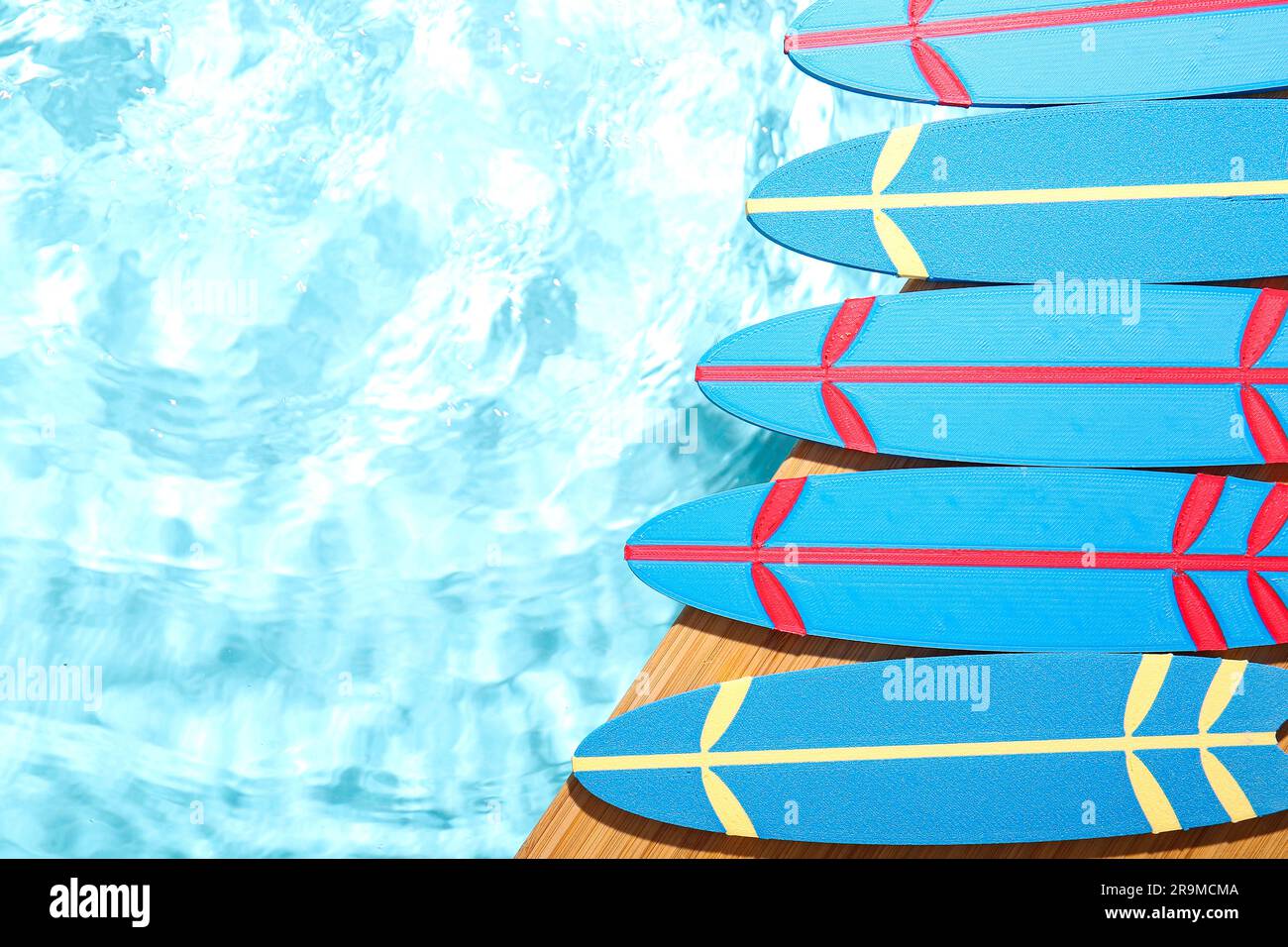 Composition with mini surfboards on edge of swimming pool Stock Photo ...