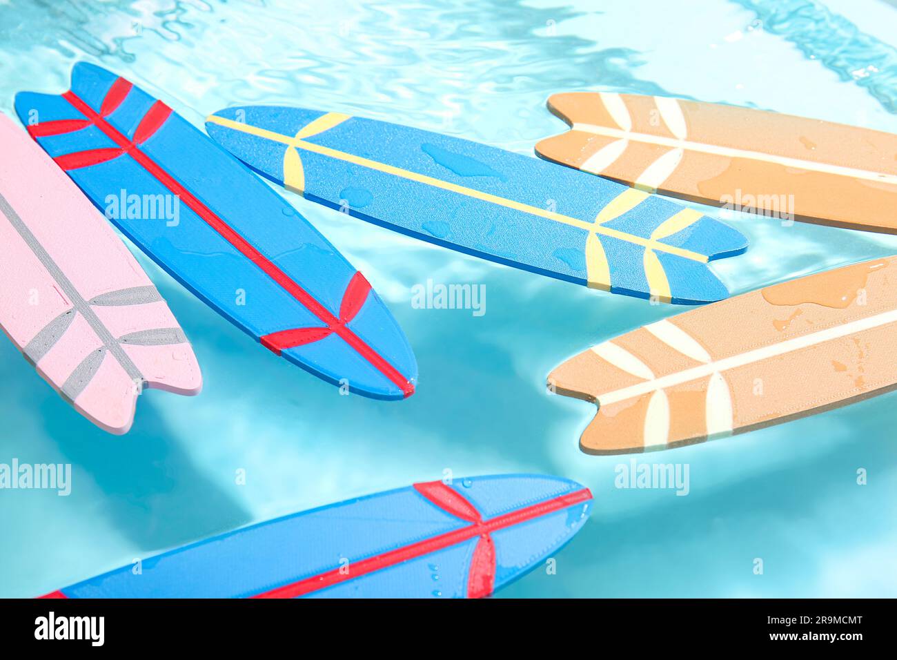 Many different mini surfboards in water Stock Photo - Alamy