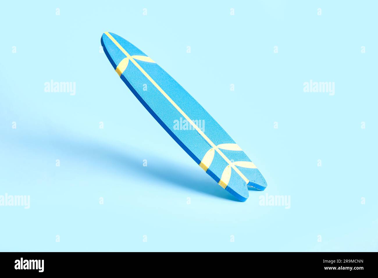 Mini color surfboard on blue background Stock Photo - Alamy
