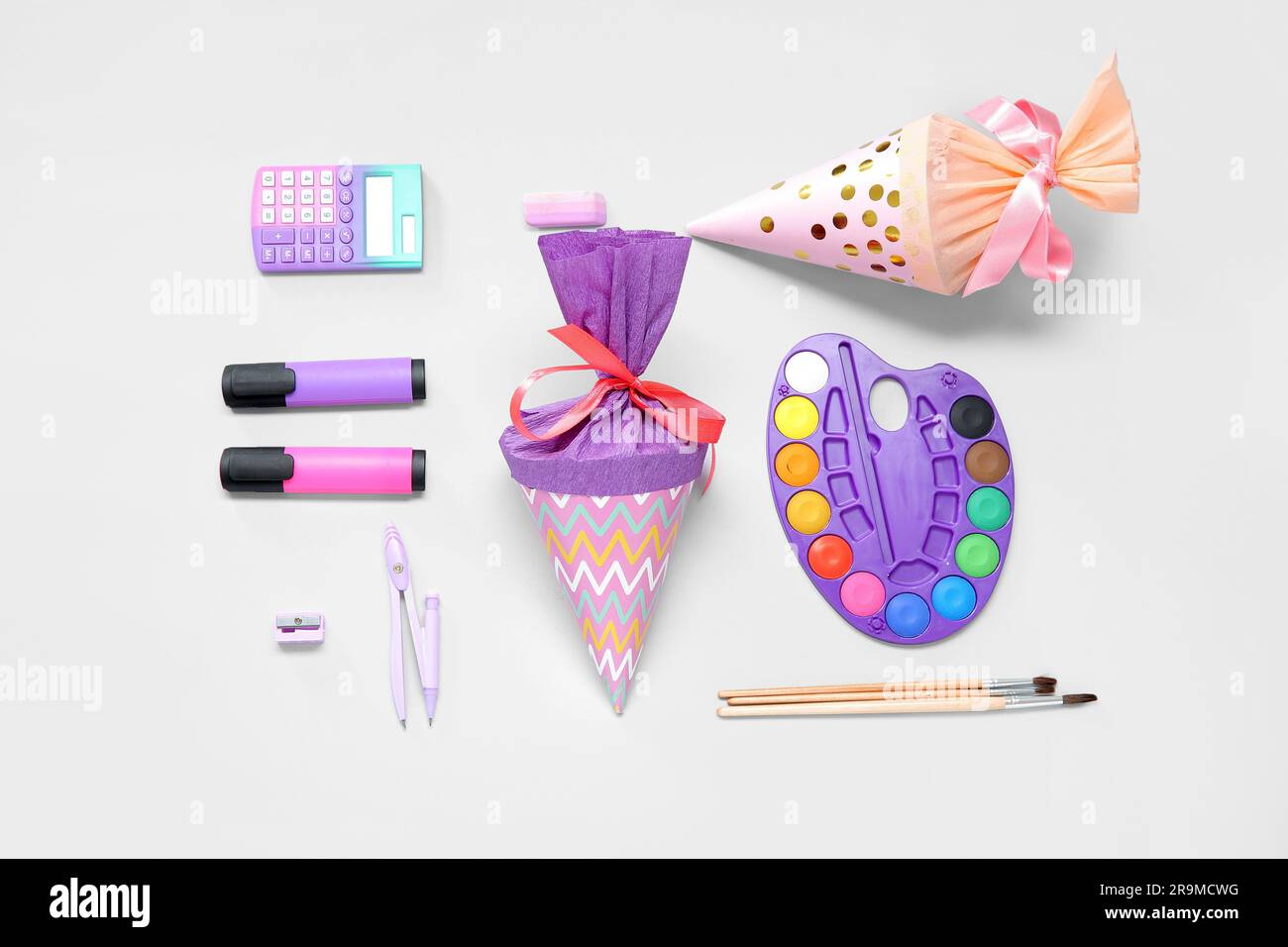 Colorful school cones with different stationery isolated on white ...