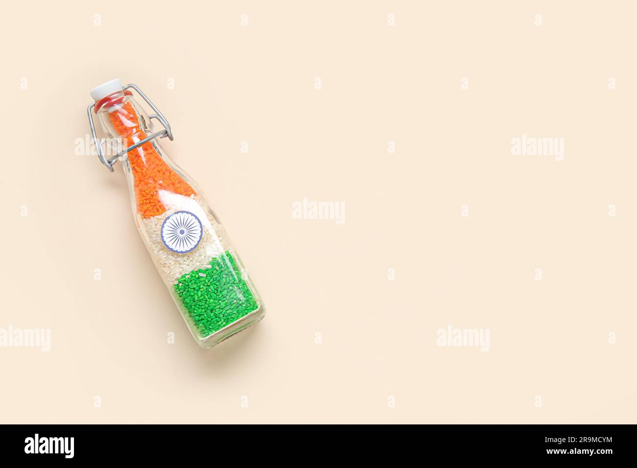 Indian flag made of rice in glass bottle on pale orange background ...
