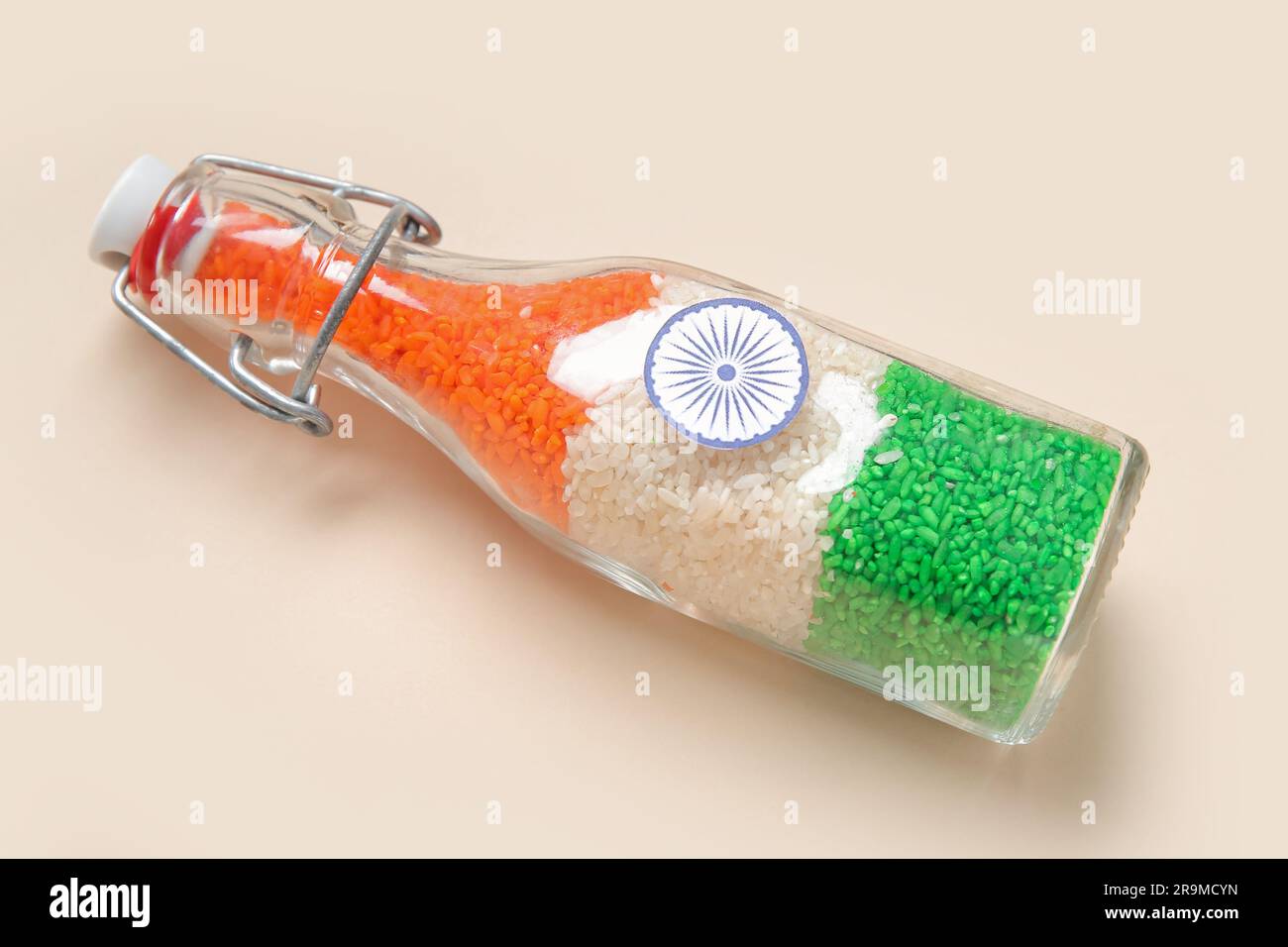 Indian flag made of rice in glass bottle on pale orange background ...