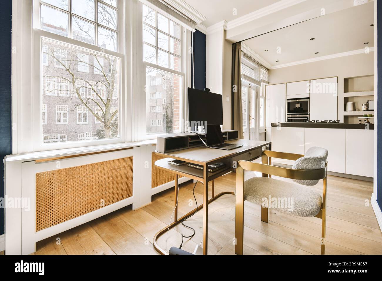 a living room with a desk, chair and television set in the middle of ...