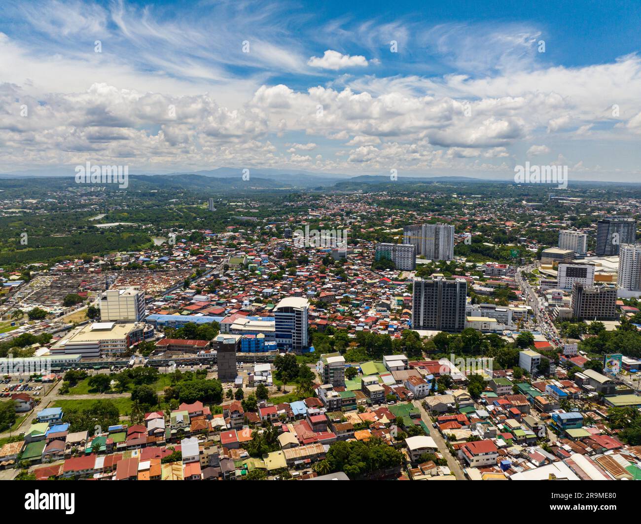 Air survey of colorful buildings and modern financial and business district of Davao City ...