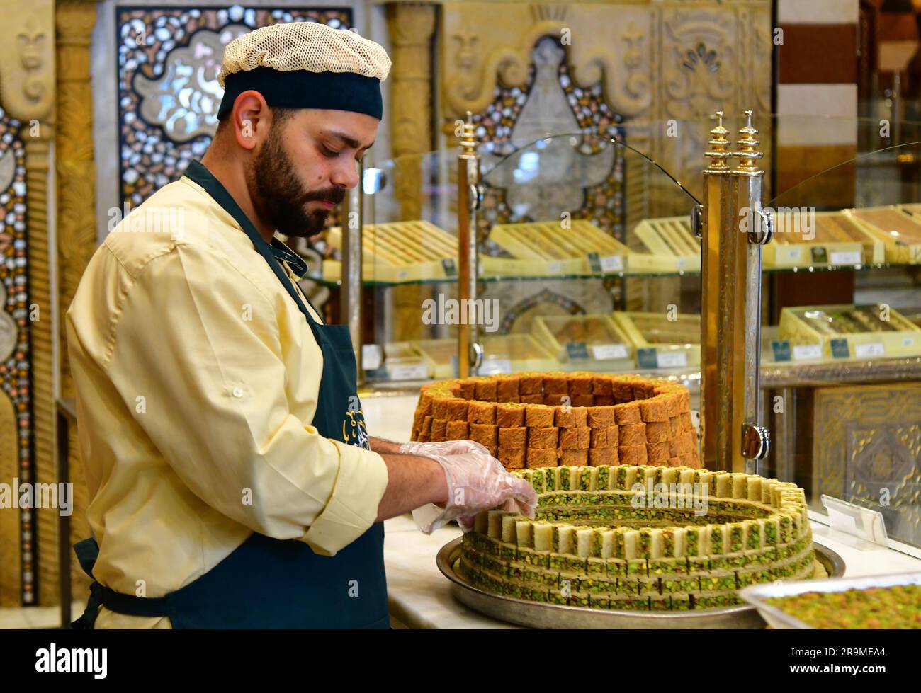 Damascus, Syria. 27th June, 2023. A sweet maker prepares special sweets ...