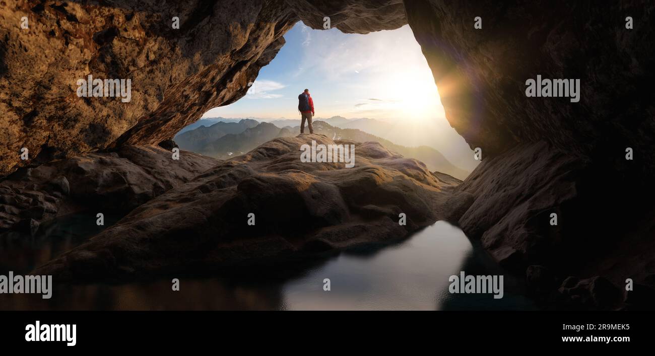 Adventurous Man Standing in cave on top of Mountain. Extreme Adventure ...