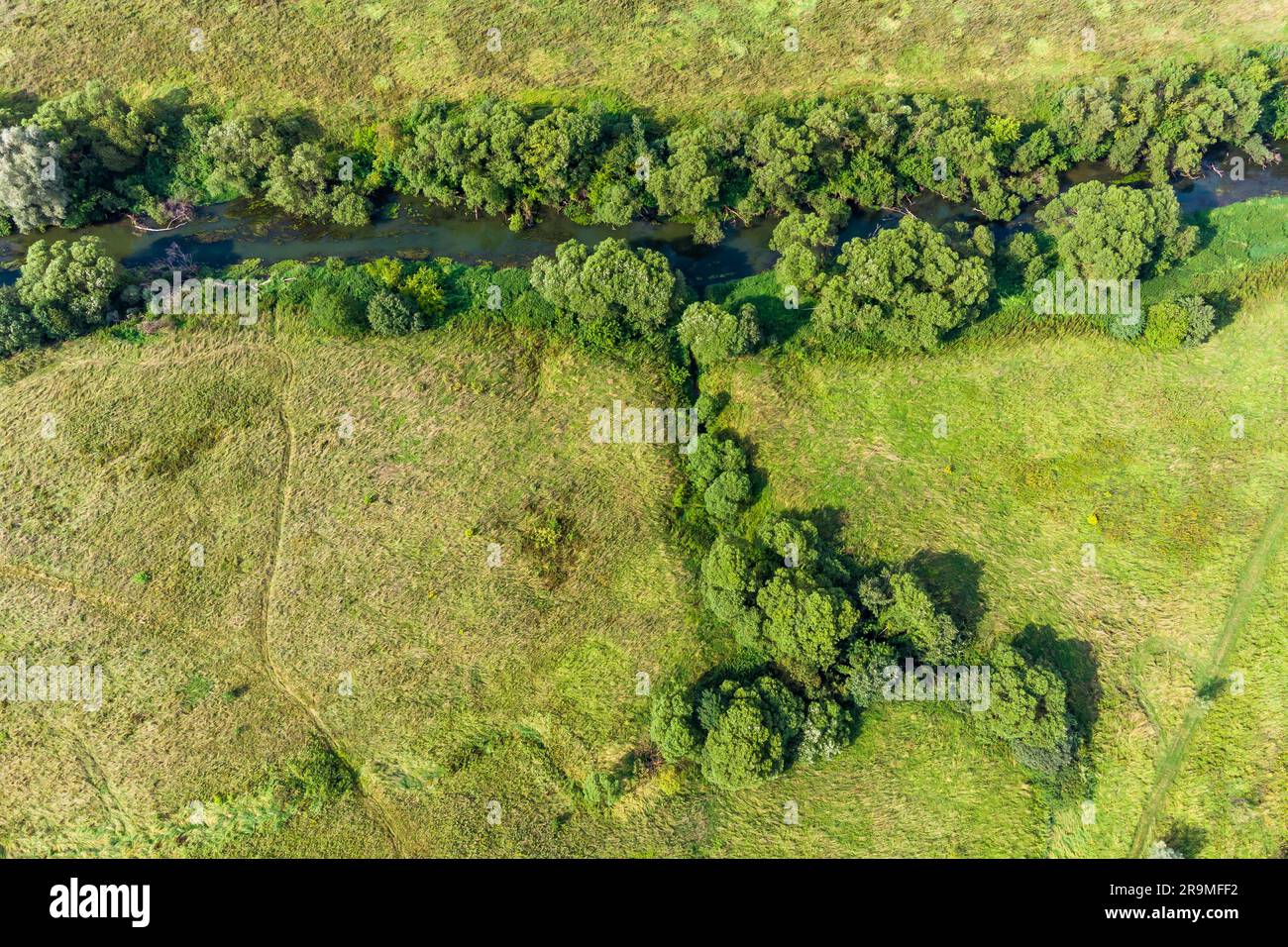The confluence of a small stream into the river, aerial view. Giblitsa ...