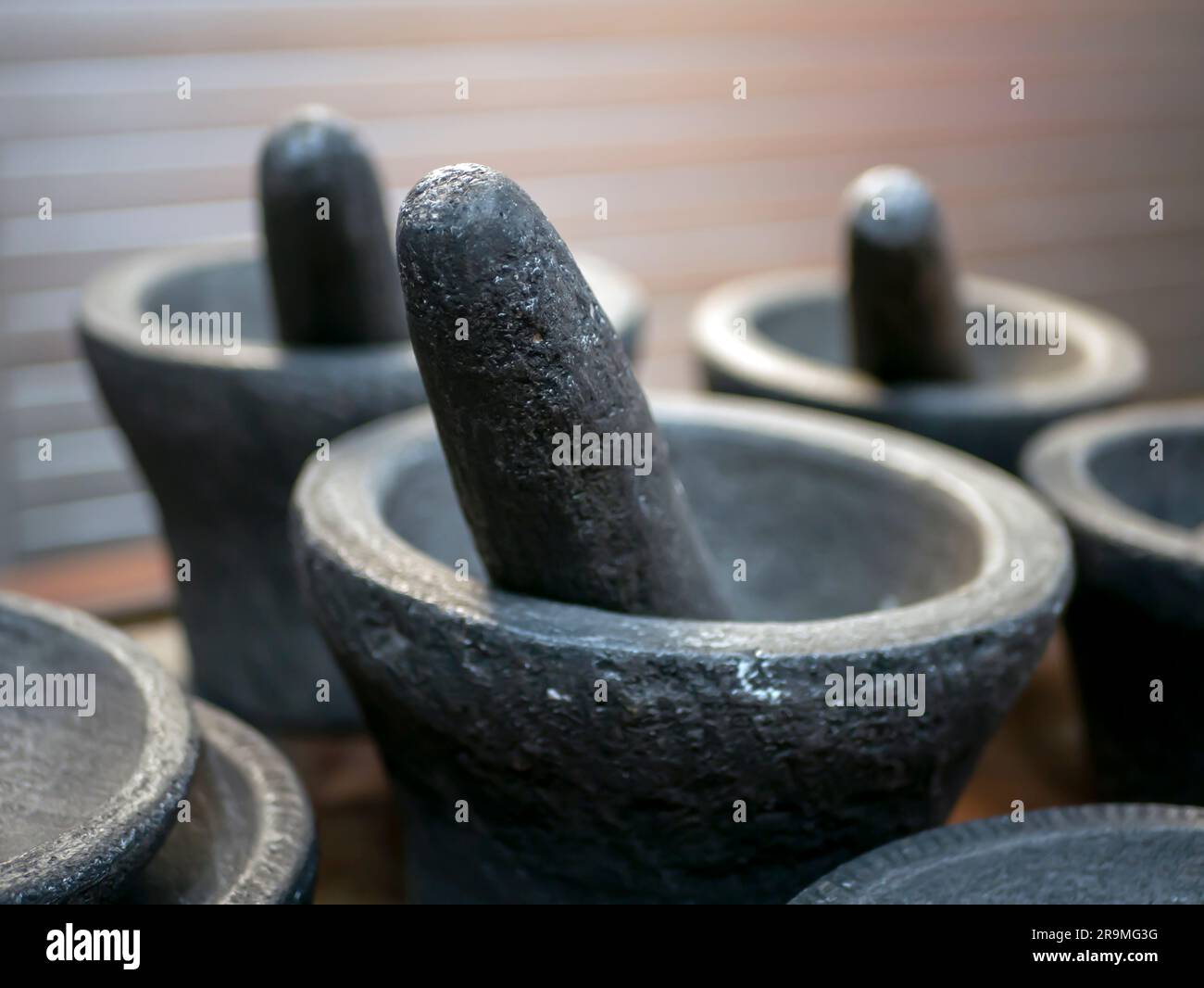 Stone mortars and pestles, a cooking tool in Asia, shallow focus. Found ...
