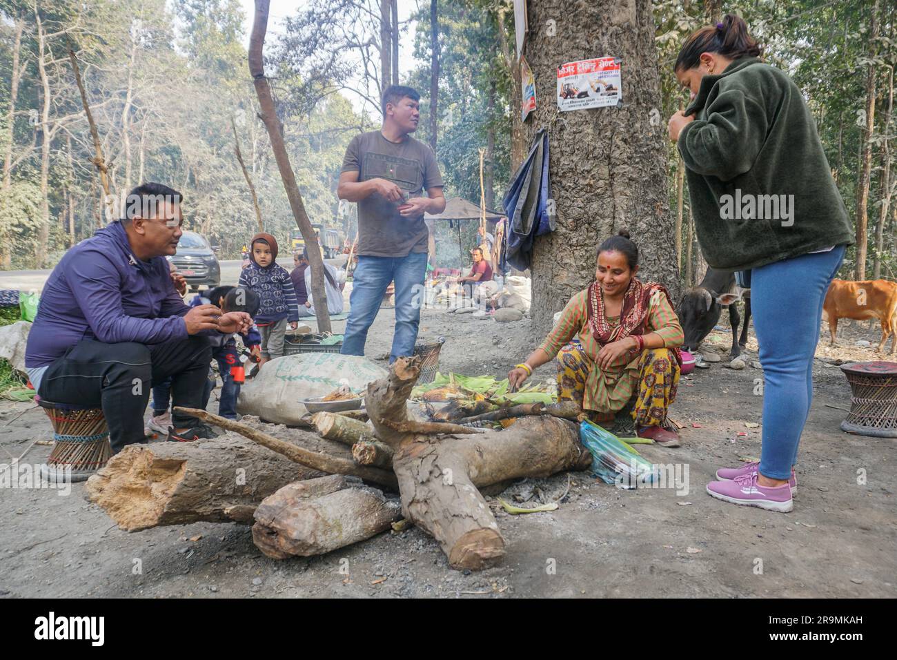 Anjana Basnet, sitting on the right, sells grilled corn along the East ...