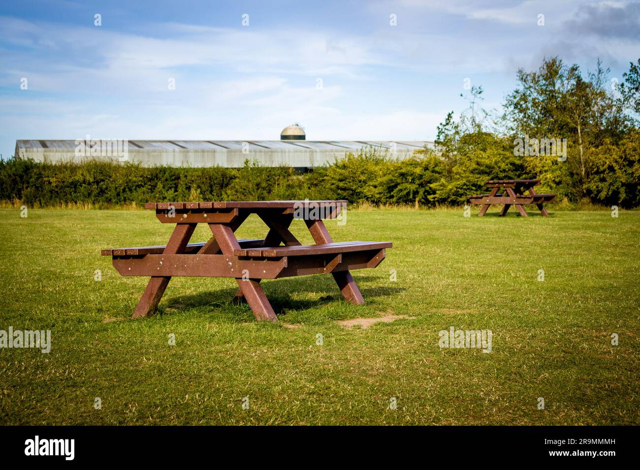 Empty bench on a field against the sky. Wetslade country park. Gosforth ...