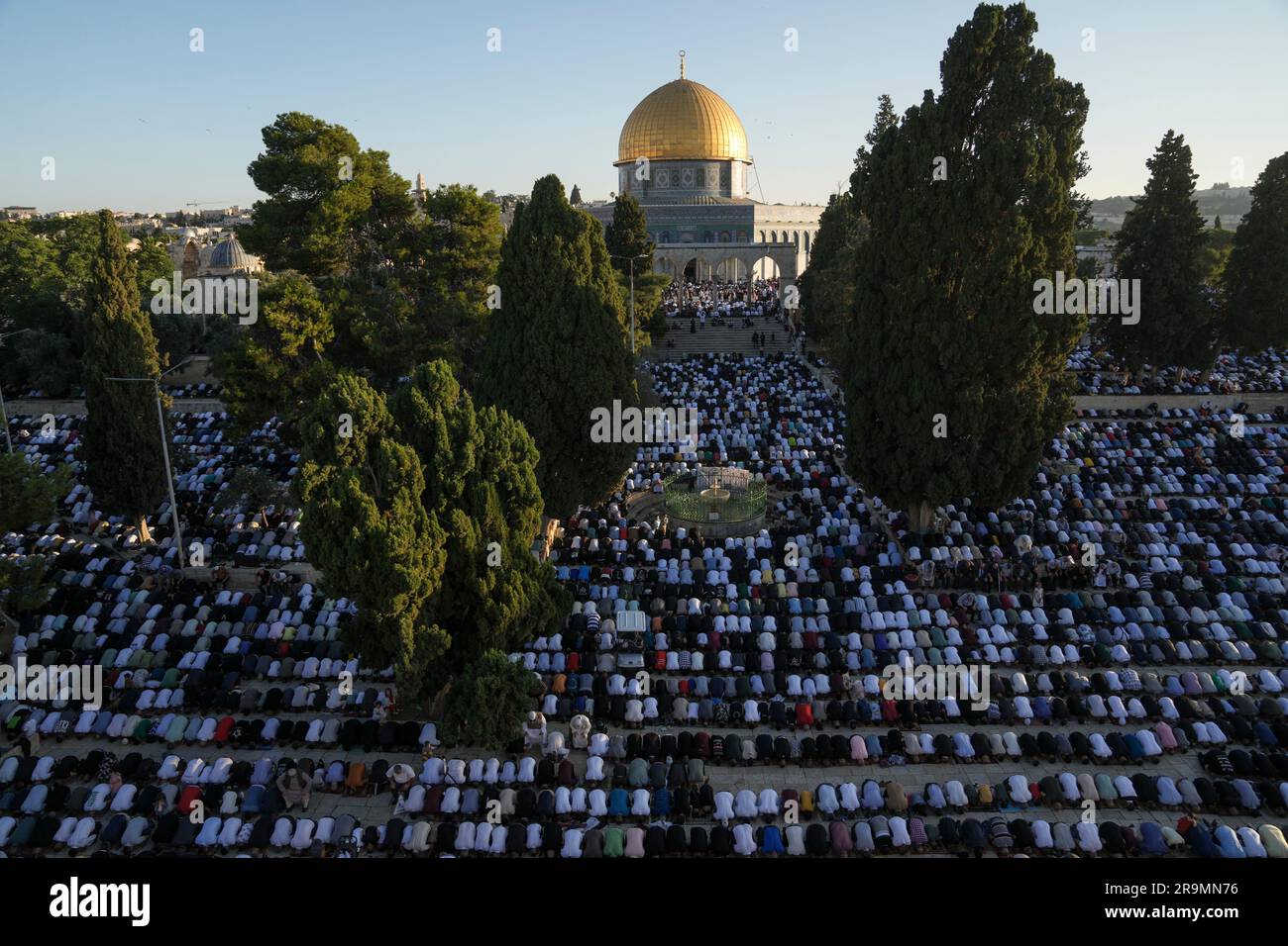 Muslim worshipers offer Eid al-Adha prayers next to the Dome of the ...
