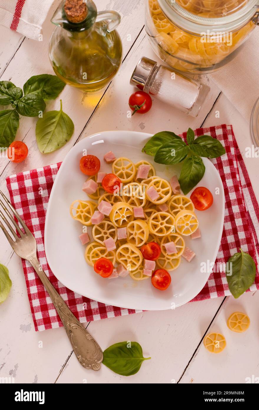 Ruote pasta with tomato and ham Stock Photo - Alamy