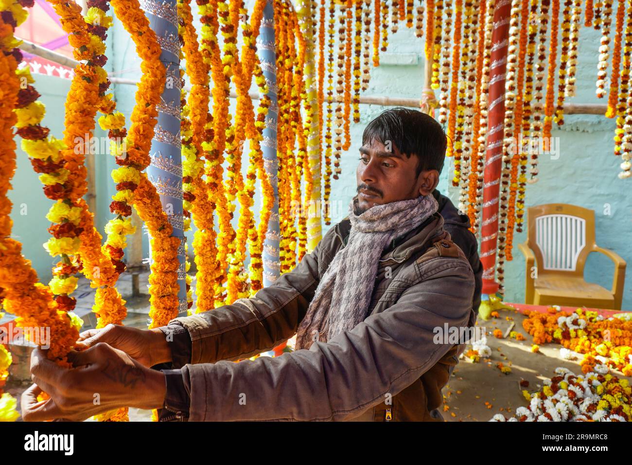 Wokil Bhandari decorates a stage with marigolds for Bratabandha, a ...