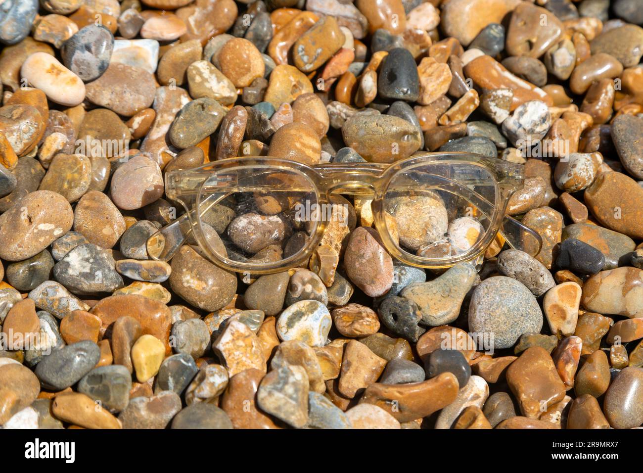 Pair of plastic spectacles glasses washed up on shingle beach, Shingle ...