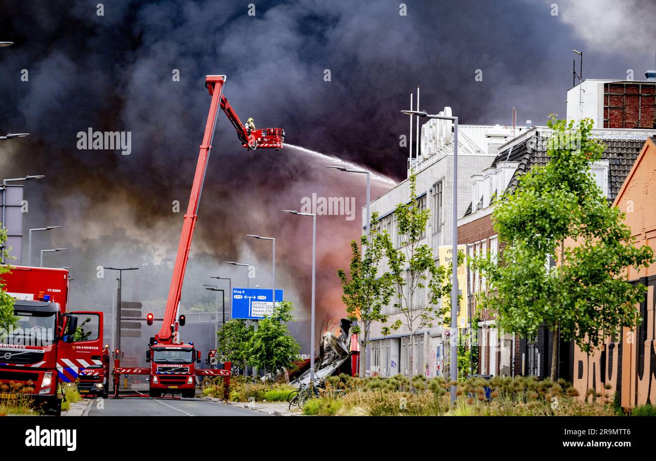 ROTTERDAM - The fire brigade extinguishes a large fire in a shed on ...