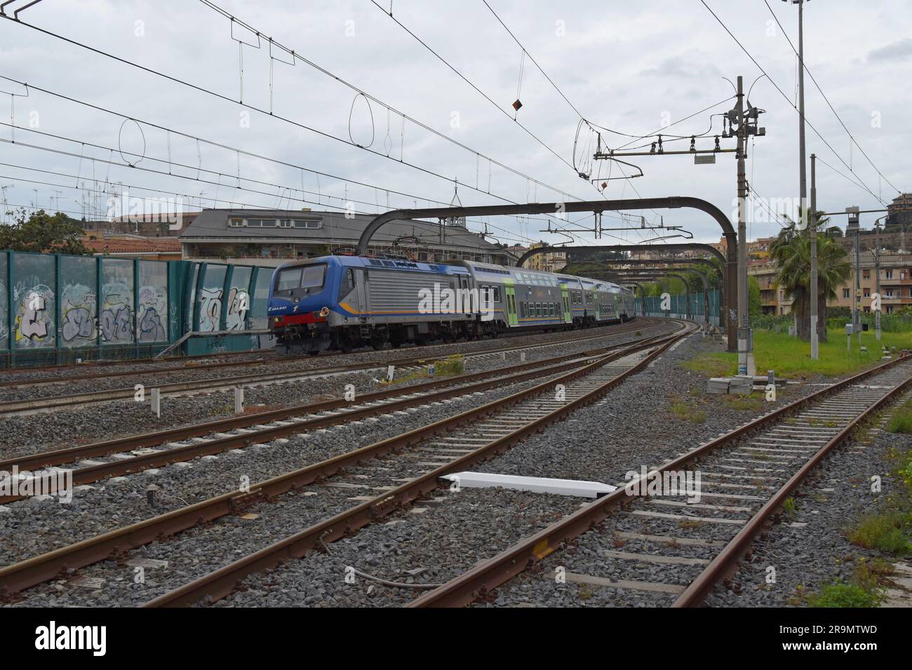 A Trenitalia FS Class E.464 loco hauling an intercity train leaving ...