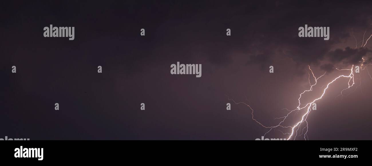 Picture of a flash in the night sky with glowing clouds in summer Stock ...