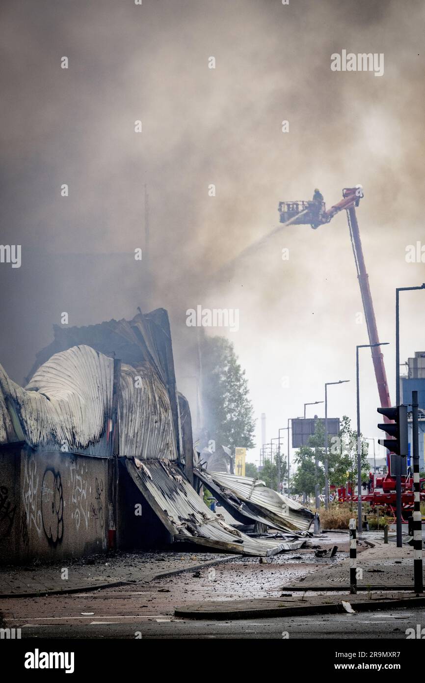 ROTTERDAM - The fire brigade extinguishes a large fire in a shed on ...