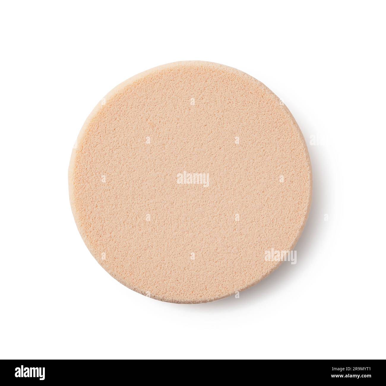 Beige makeup sponge placed on a white background. Viewed from above ...